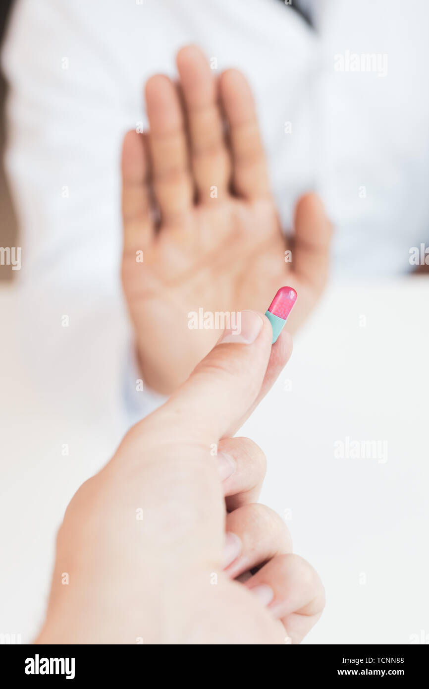 Patient refusing to use medication . Doctor or pharmacist giving pills ...