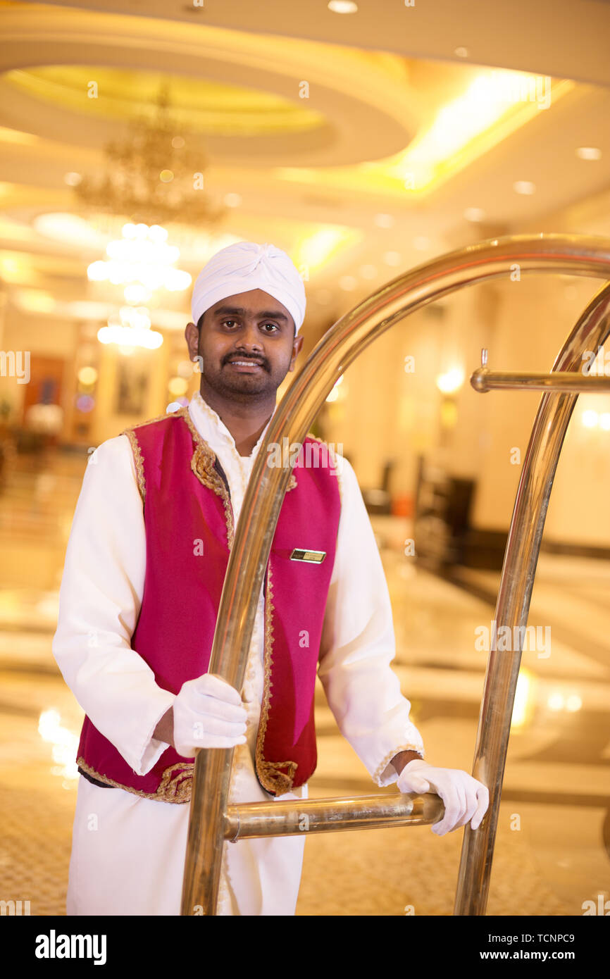 young indian porter service in luxury hotel lobby Stock Photo - Alamy