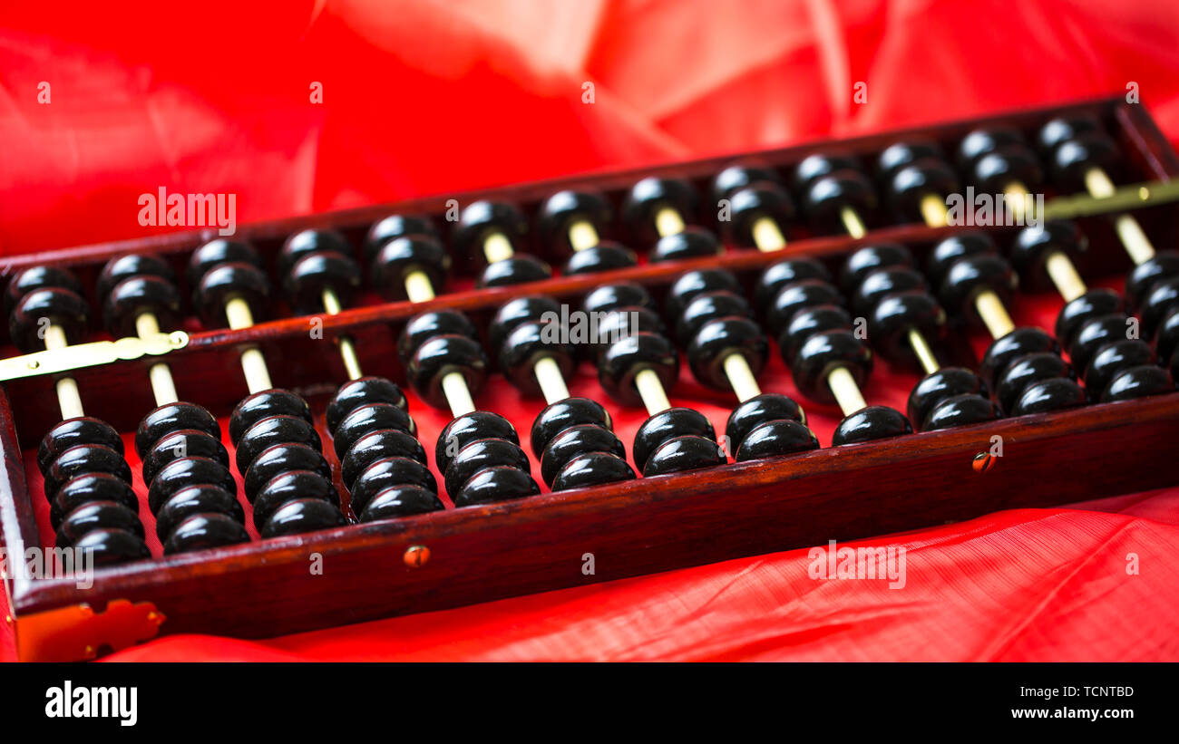 Abacus on red satin Stock Photo - Alamy