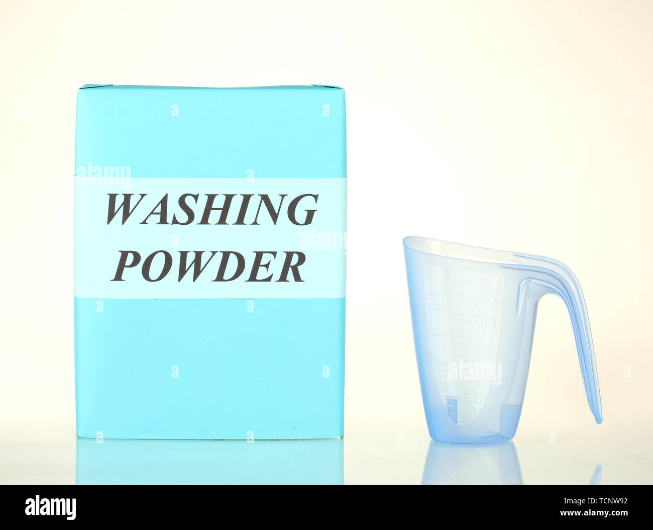 Box of washing powder with blue measuring cup isolated on white Stock ...