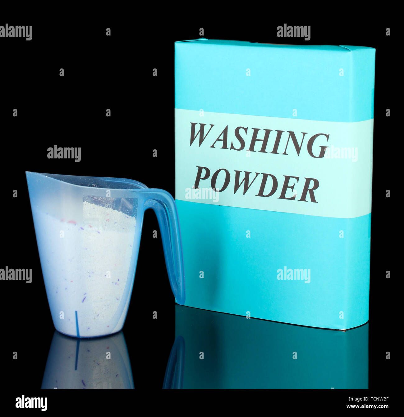 Box of washing powder with blue measuring cup, isolated on black Stock ...