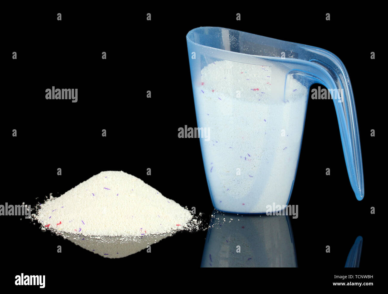 washing powder in a measuring cup, isolated on black Stock Photo - Alamy