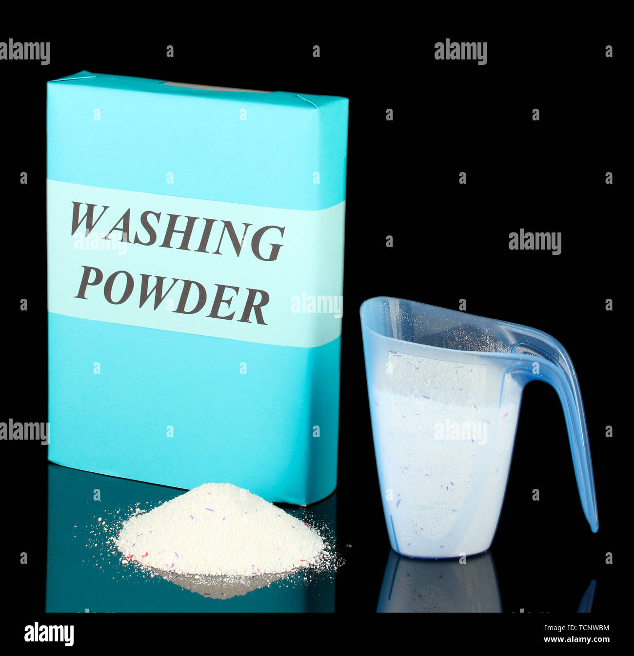 Box of washing powder with blue measuring cup, isolated on black Stock ...