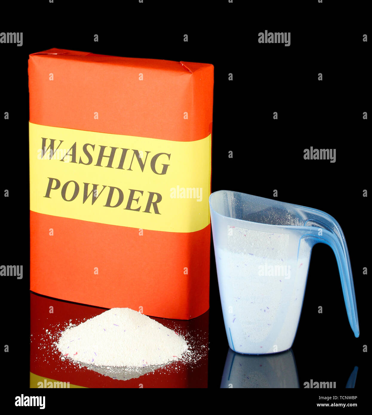 Box of washing powder with blue measuring cup, isolated on black Stock ...