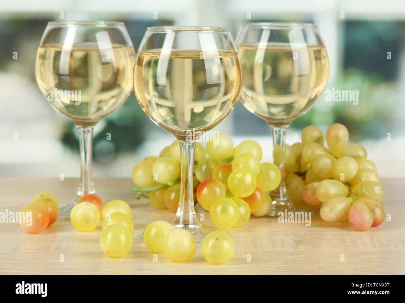 White wine in glass on window background Stock Photo - Alamy