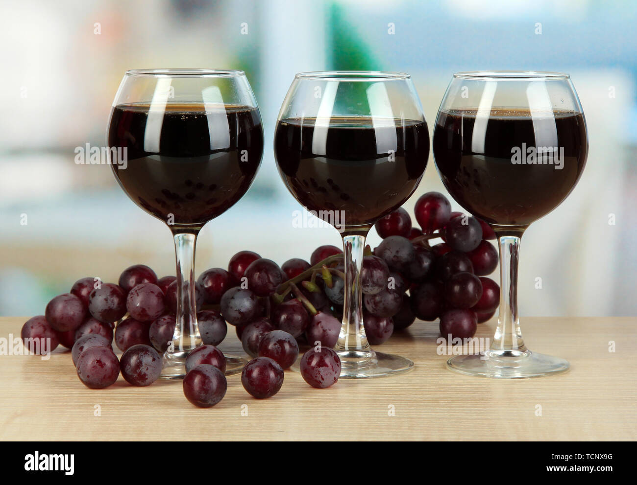 Red wine in glass on room background Stock Photo - Alamy