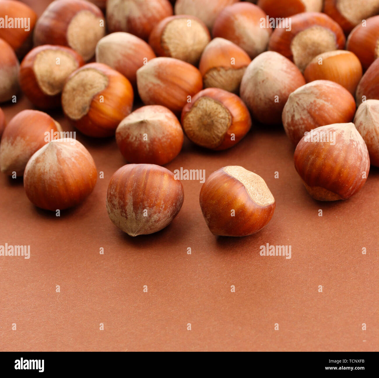 tasty hazelnuts, on brown background Stock Photo - Alamy