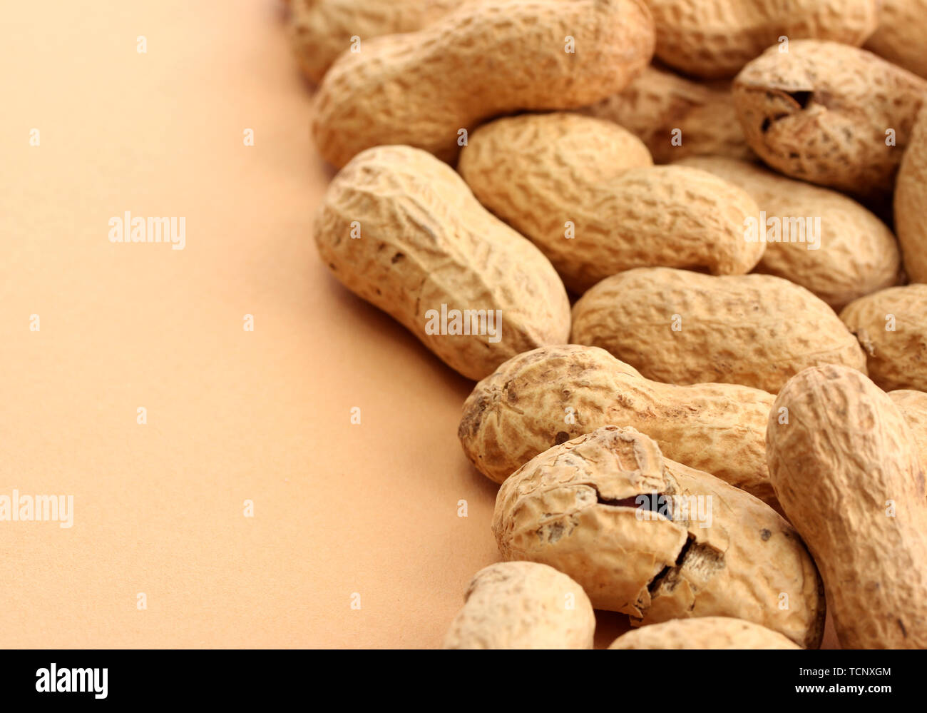 tasty peanuts, on beige background Stock Photo - Alamy