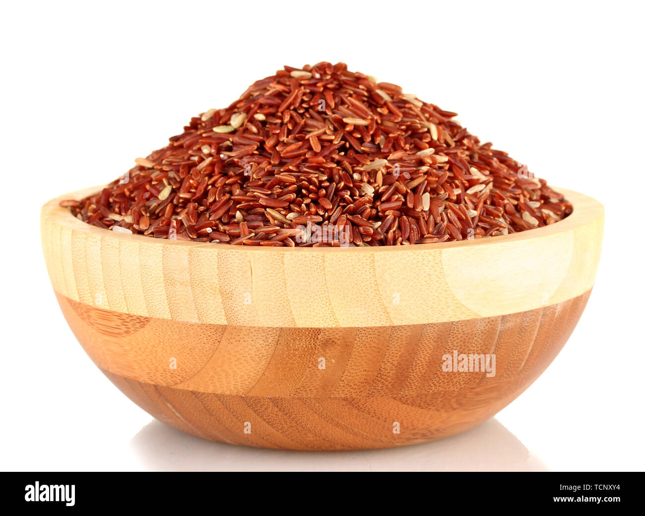 red rice in a brown wooden plat, isolated on white Stock Photo - Alamy