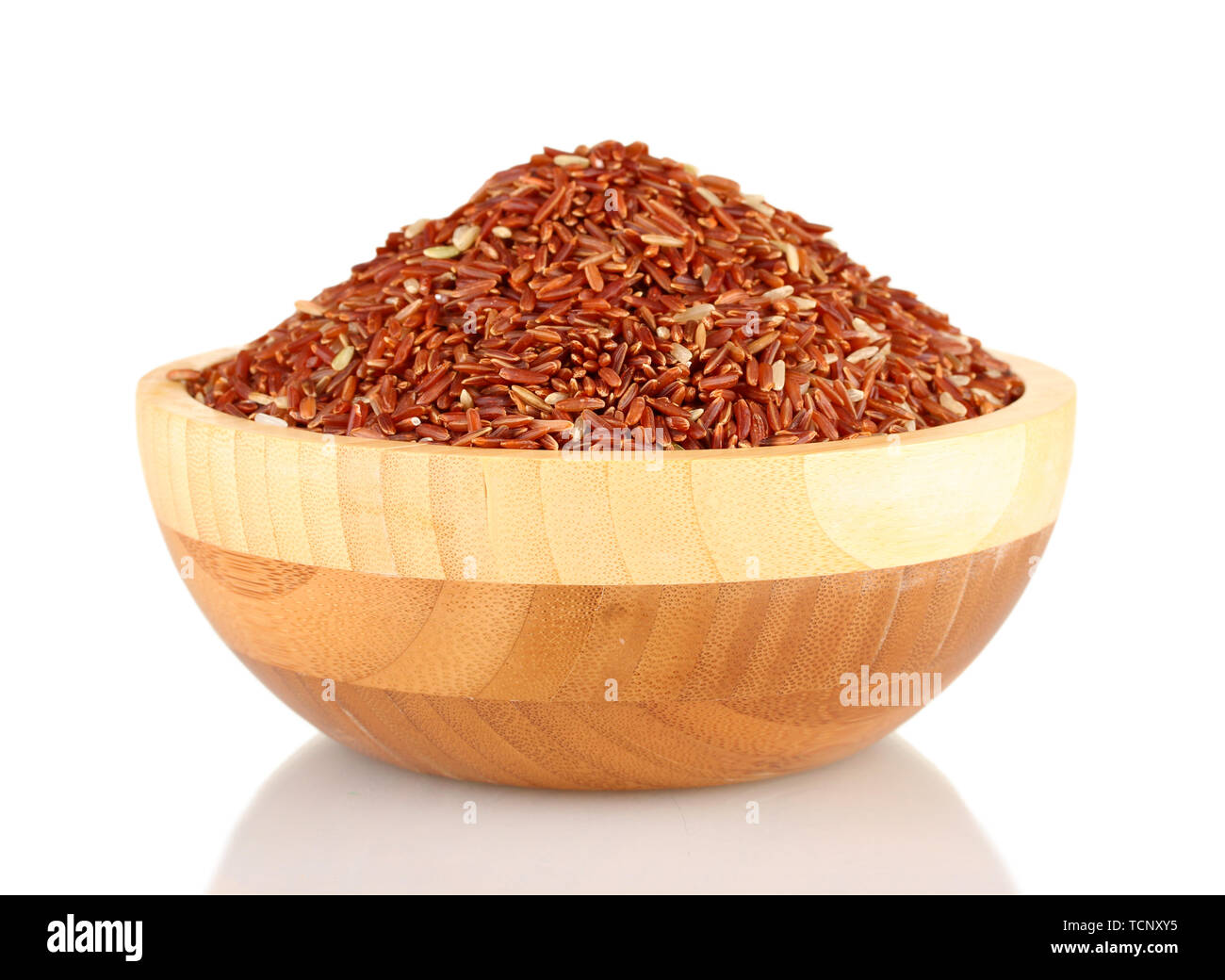 red rice in a brown wooden plat, isolated on white Stock Photo - Alamy