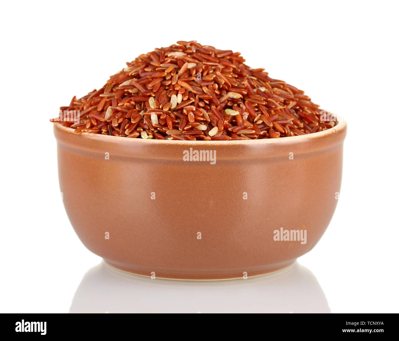red rice in a brown plate , isolated on white Stock Photo - Alamy