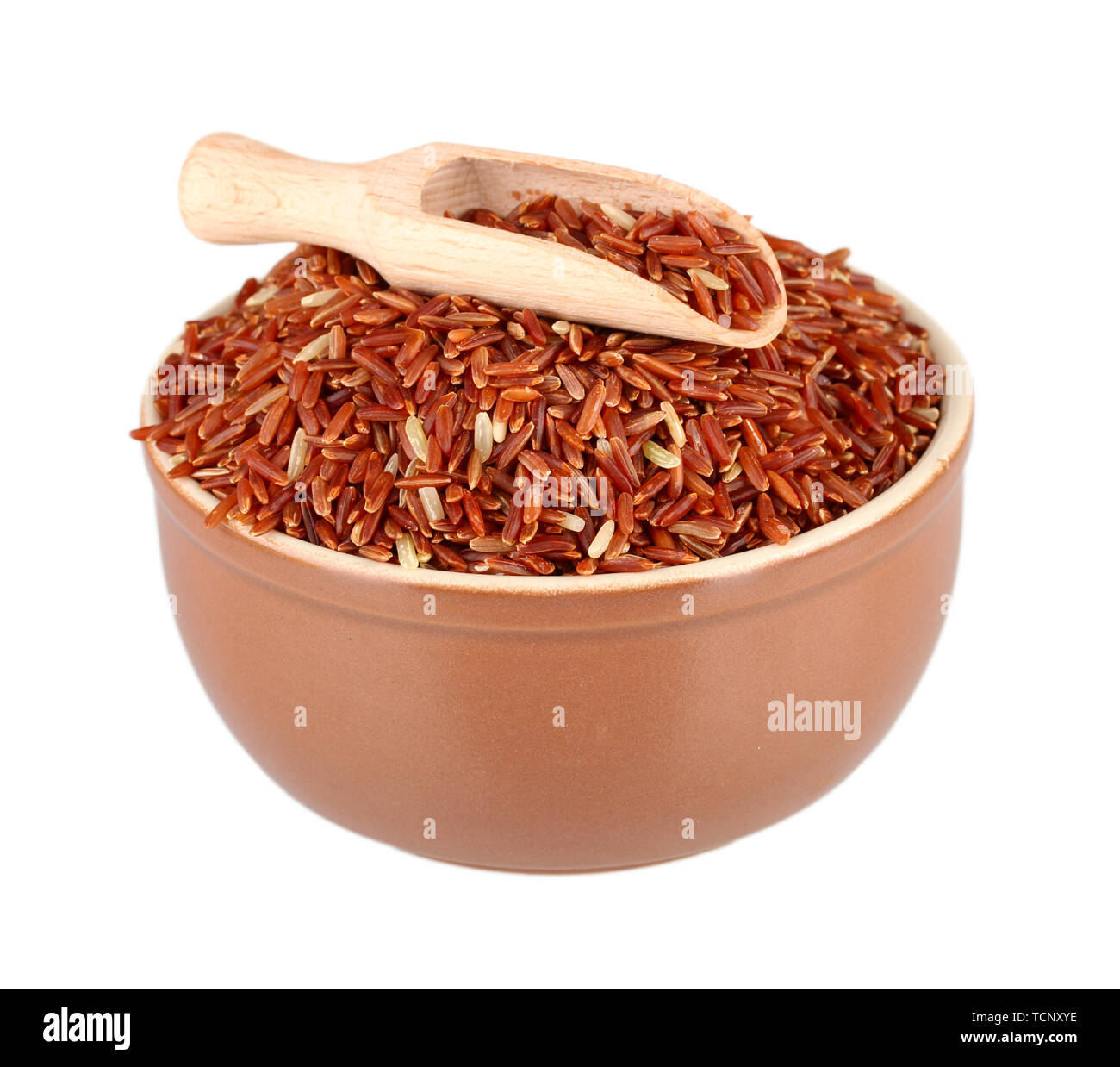 red rice in a brown platewith a wooden scoop , isolated on white Stock ...