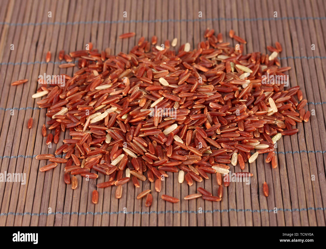 red rice on bamboo mat Stock Photo - Alamy