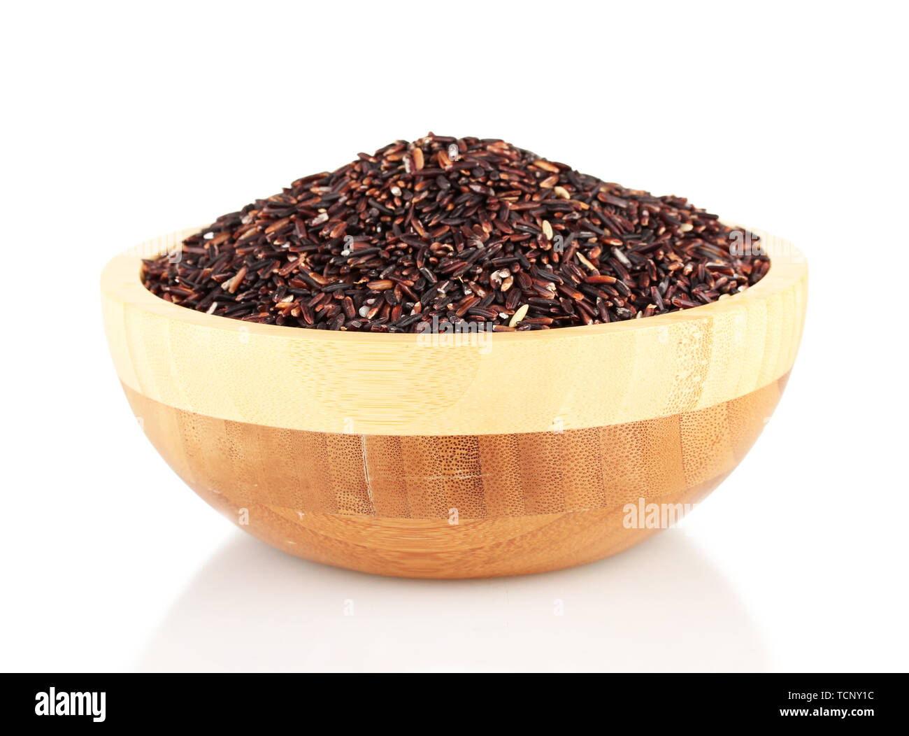 black rice in a brown wooden plat, isolated on white Stock Photo - Alamy