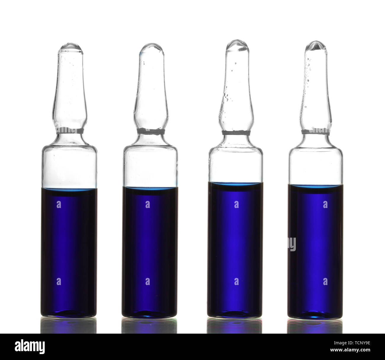 medical ampules with blue liquid, isolated on white Stock Photo - Alamy