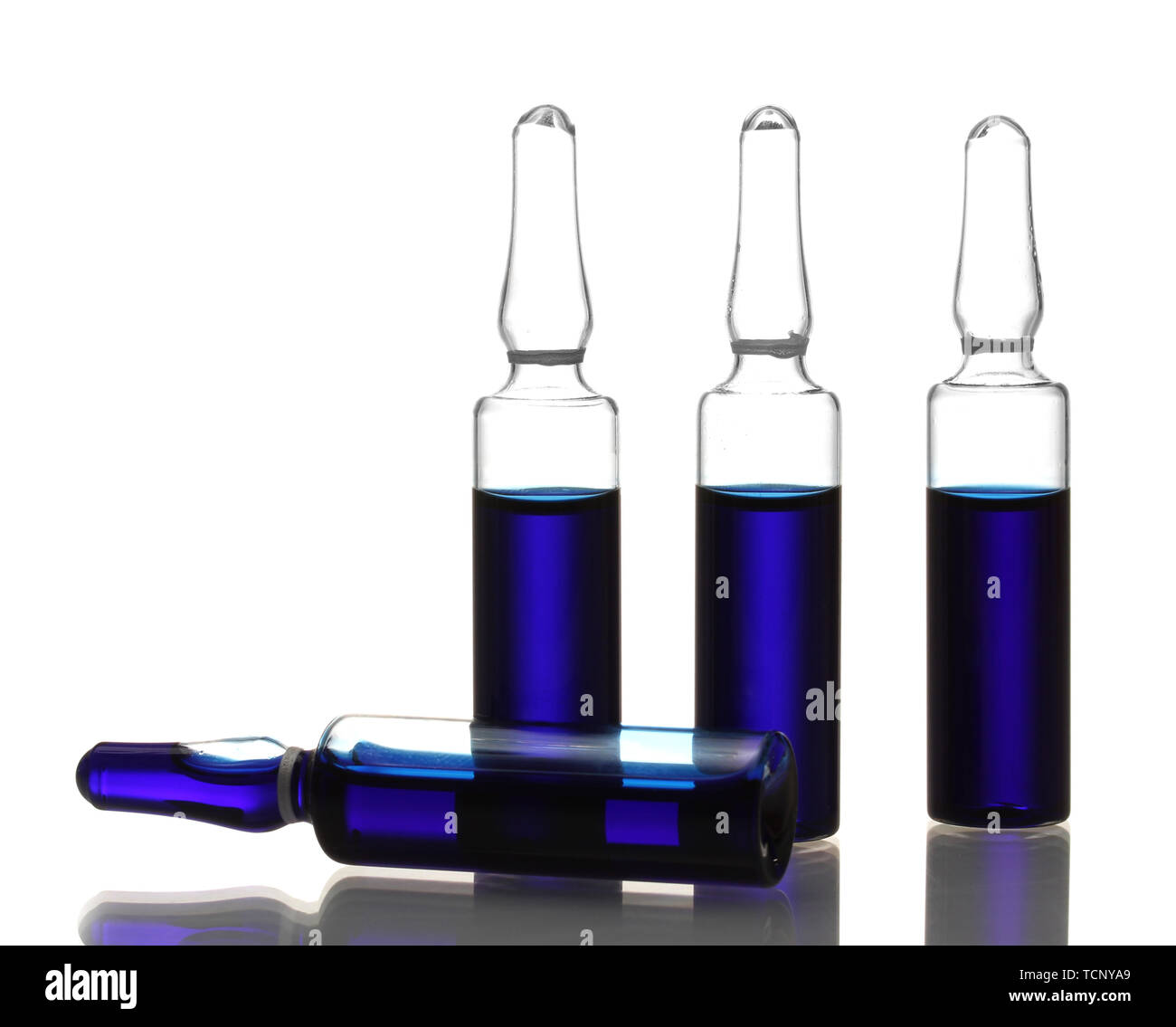 medical ampules with blue liquid, isolated on white Stock Photo - Alamy