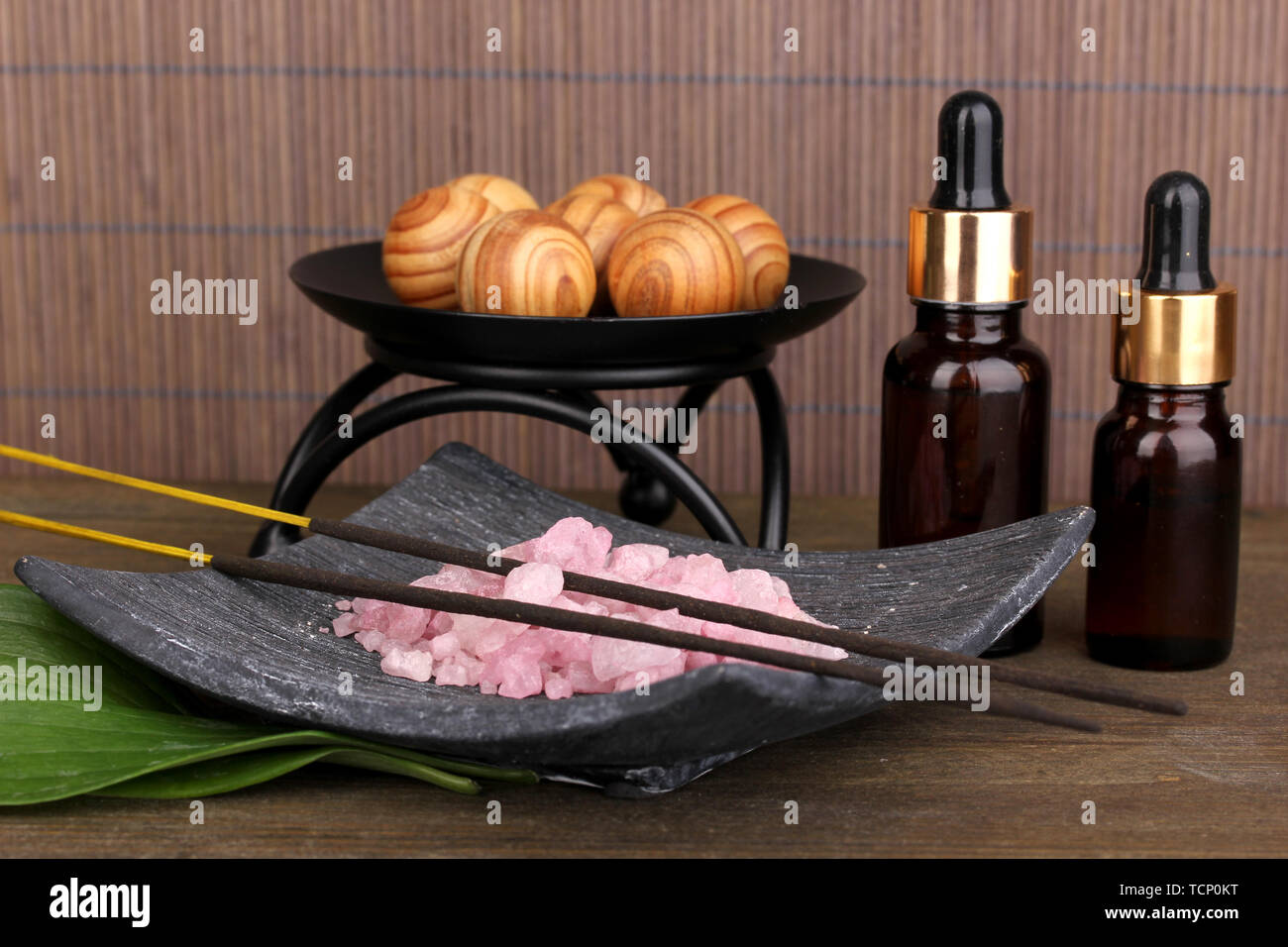 aromatherapy setting on brown bamboo background Stock Photo - Alamy