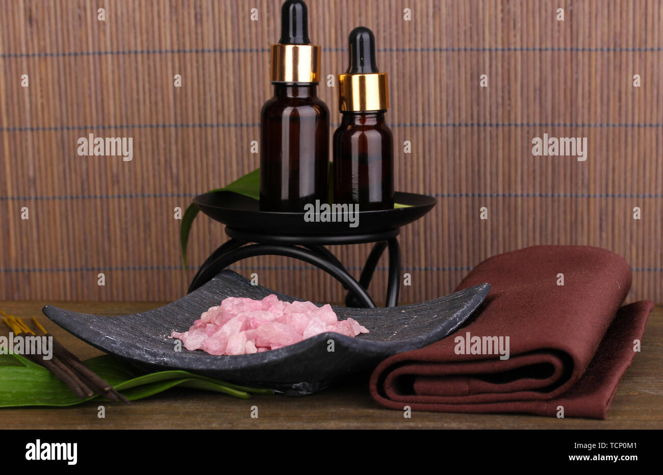 aromatherapy setting on brown bamboo background Stock Photo - Alamy