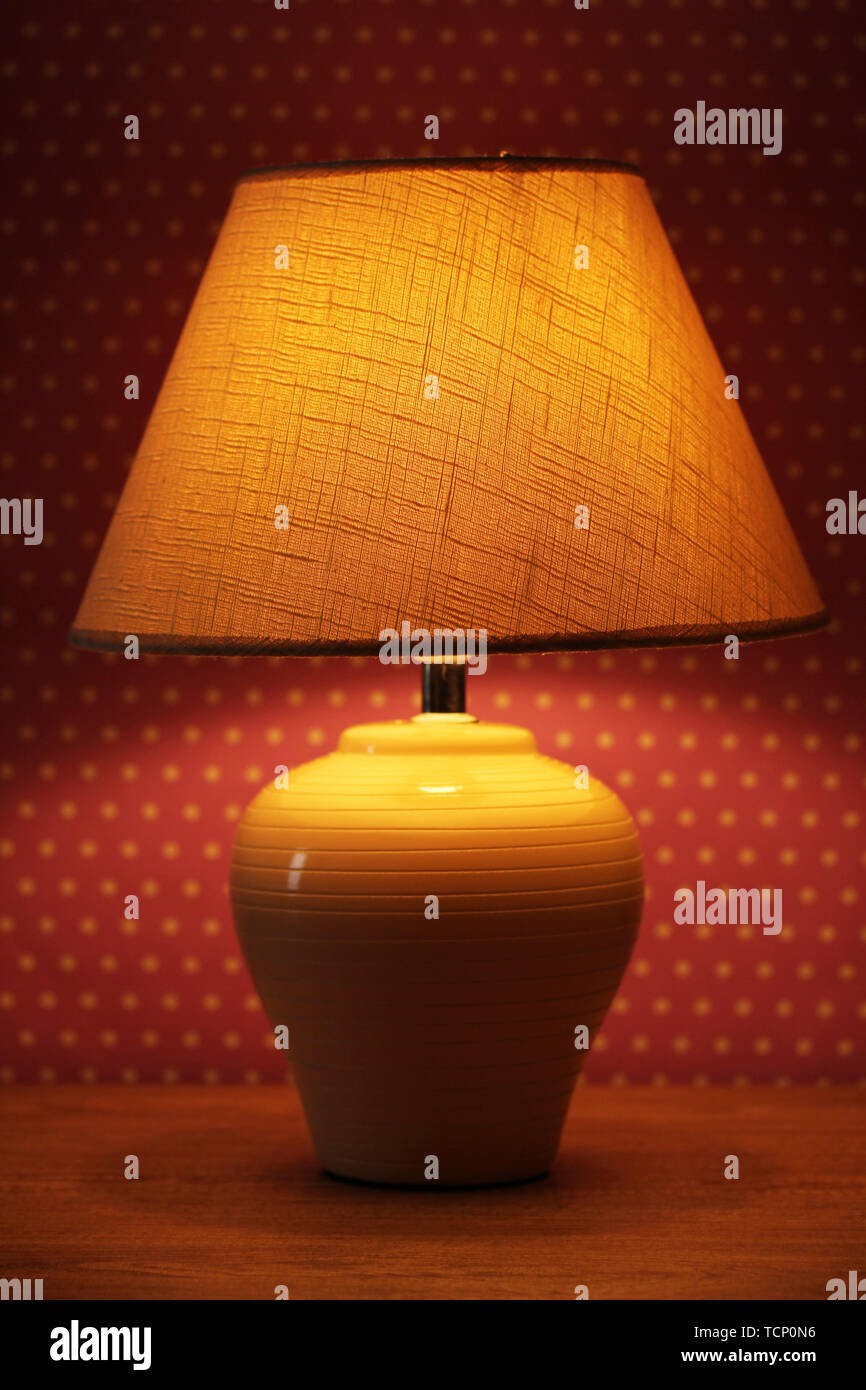 table lamp on wallpaper background Stock Photo - Alamy