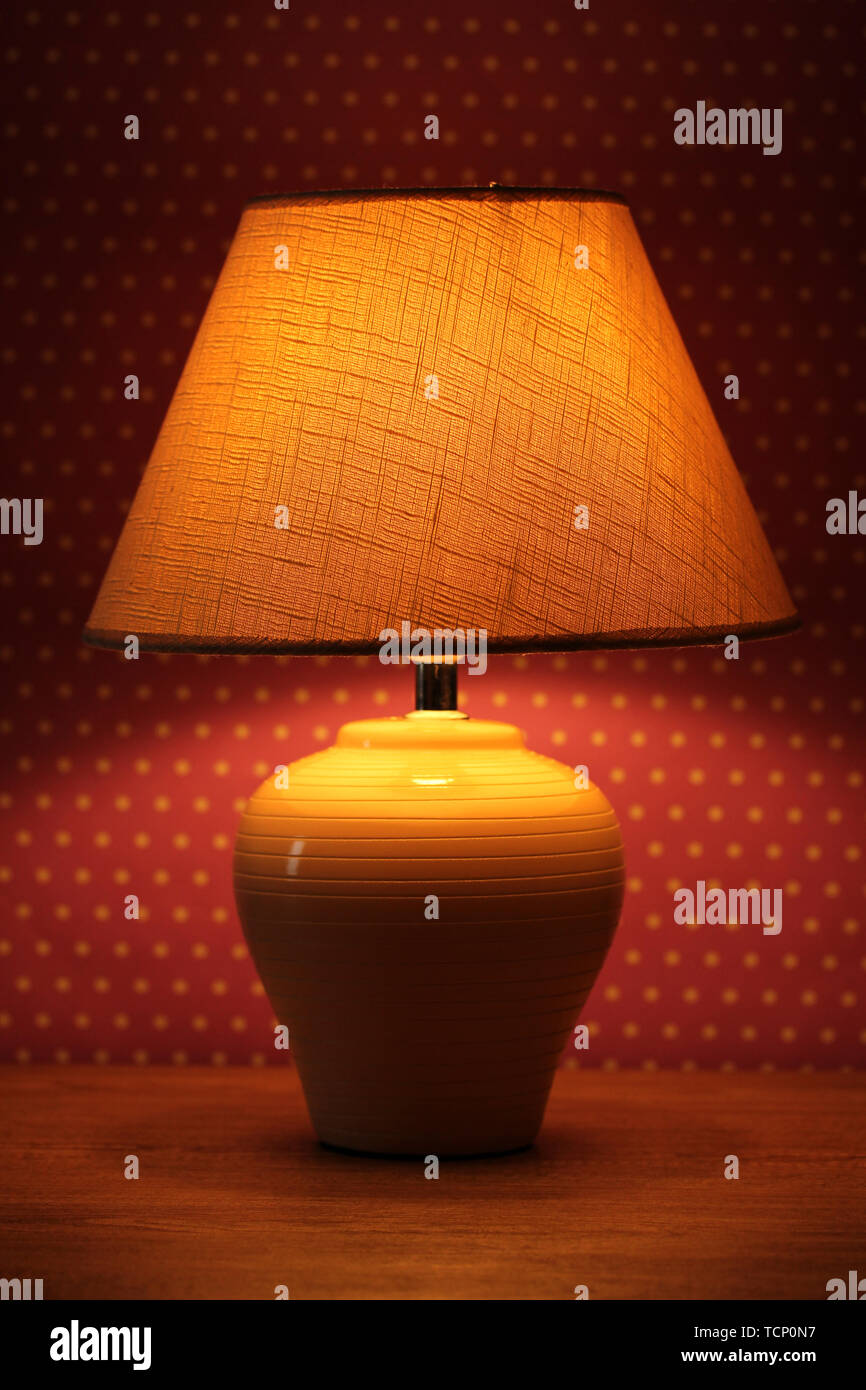 table lamp on wallpaper background Stock Photo - Alamy