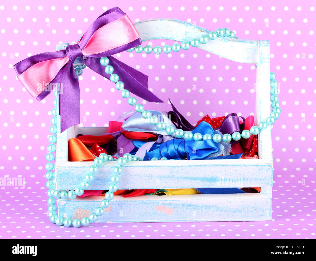 bows in wooden box on color background Stock Photo - Alamy