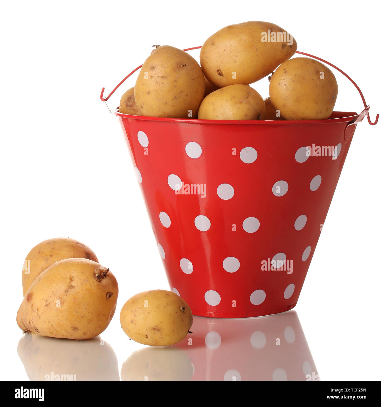 Ripe potatoes in red pail isolated on white Stock Photo - Alamy
