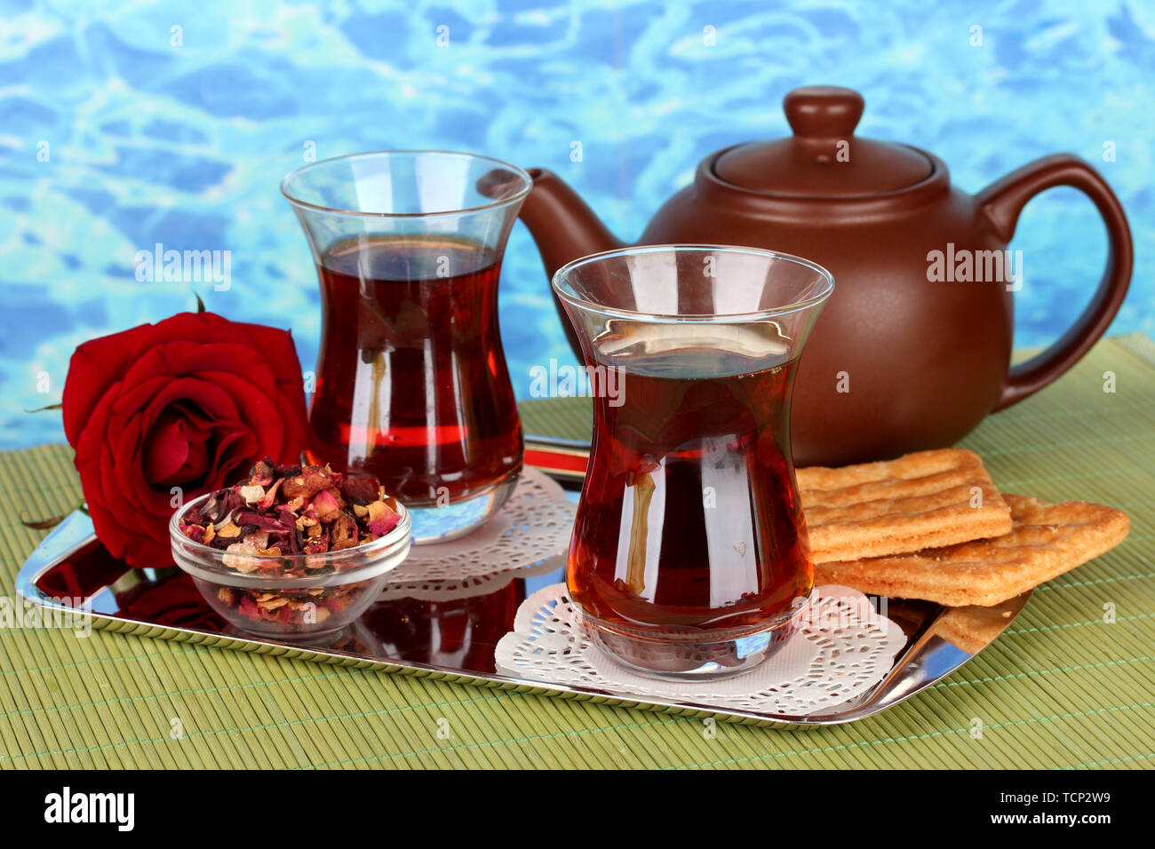 glass of Turkish tea and kettle on color background Stock Photo - Alamy