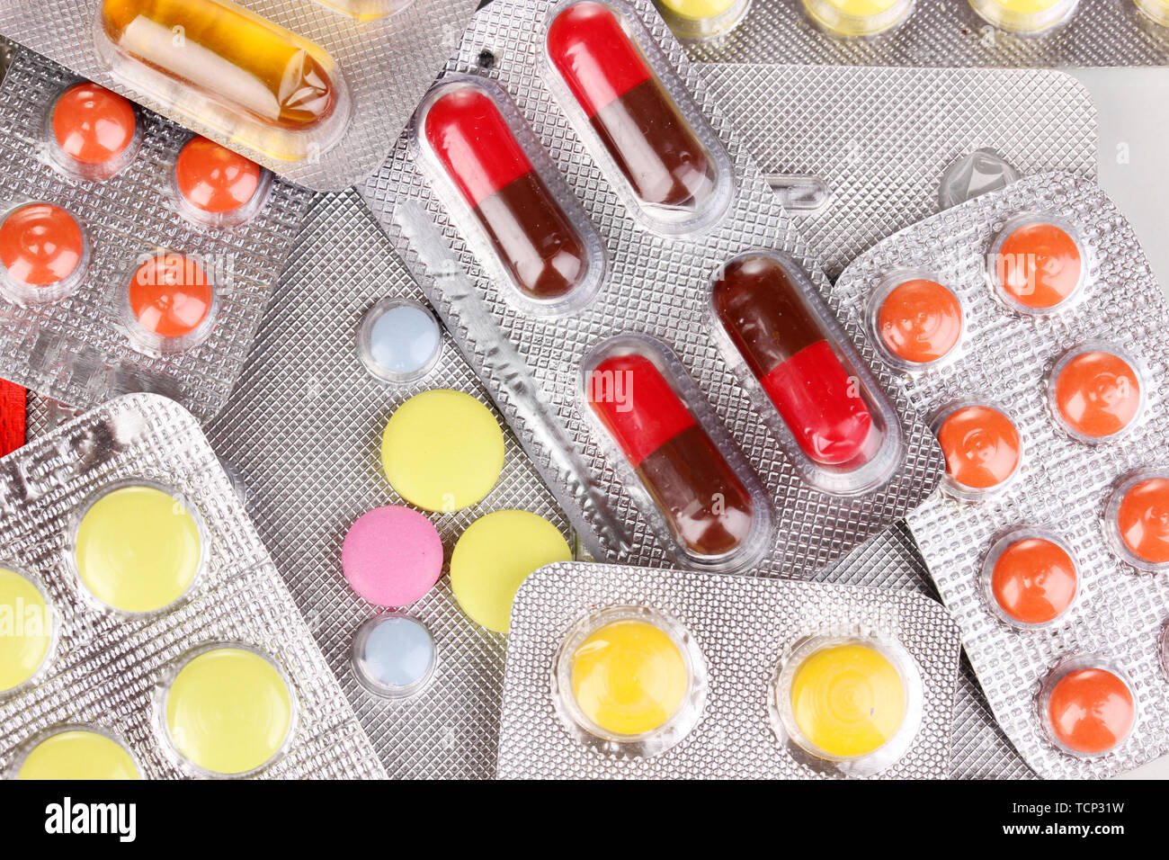 Capsules and pills packed in blisters close-up background Stock Photo ...
