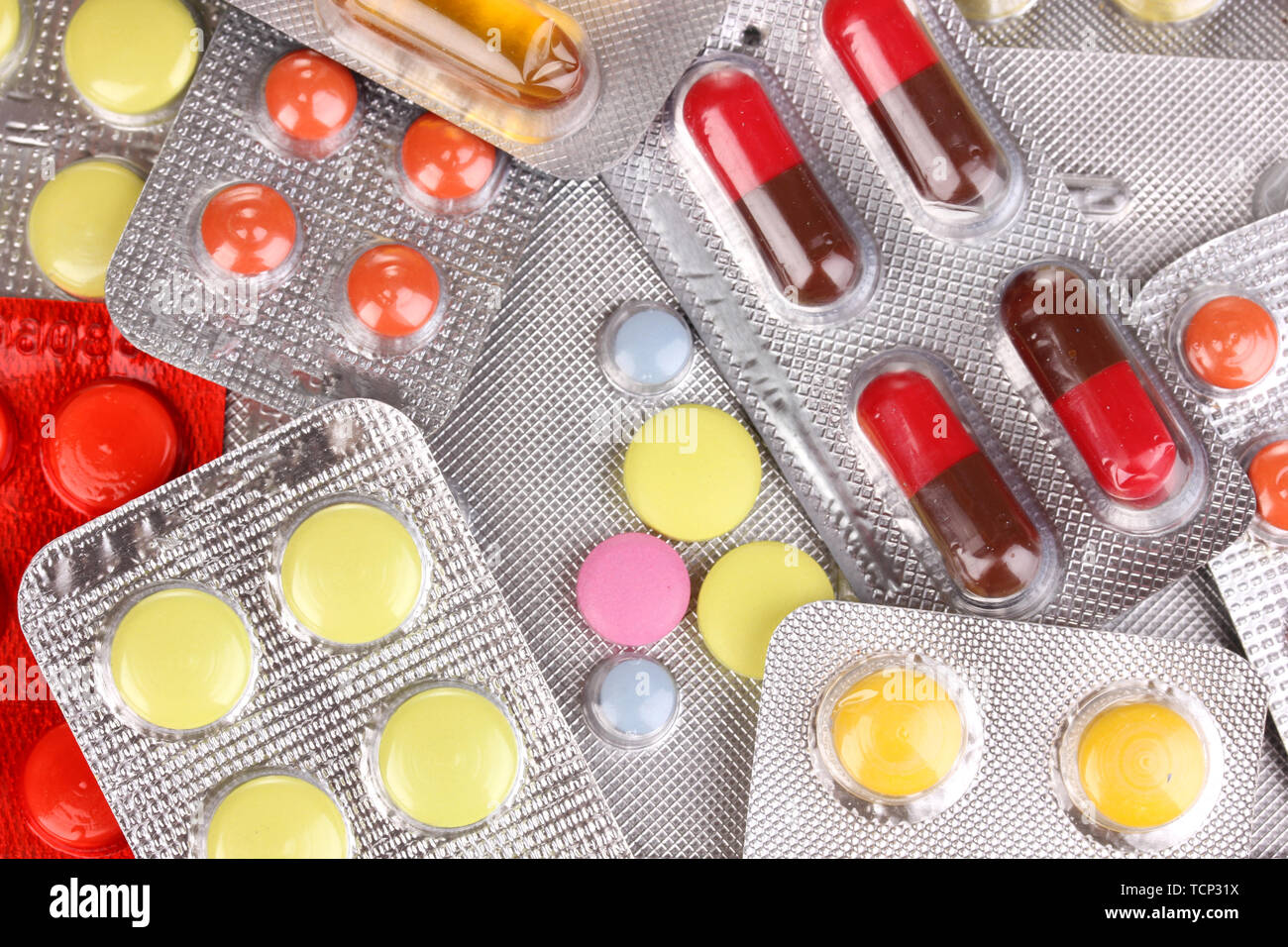 Capsules and pills packed in blisters close-up background Stock Photo ...