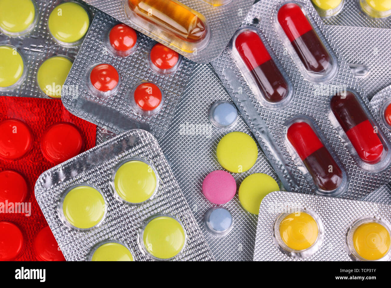 Capsules and pills packed in blisters close-up background Stock Photo ...