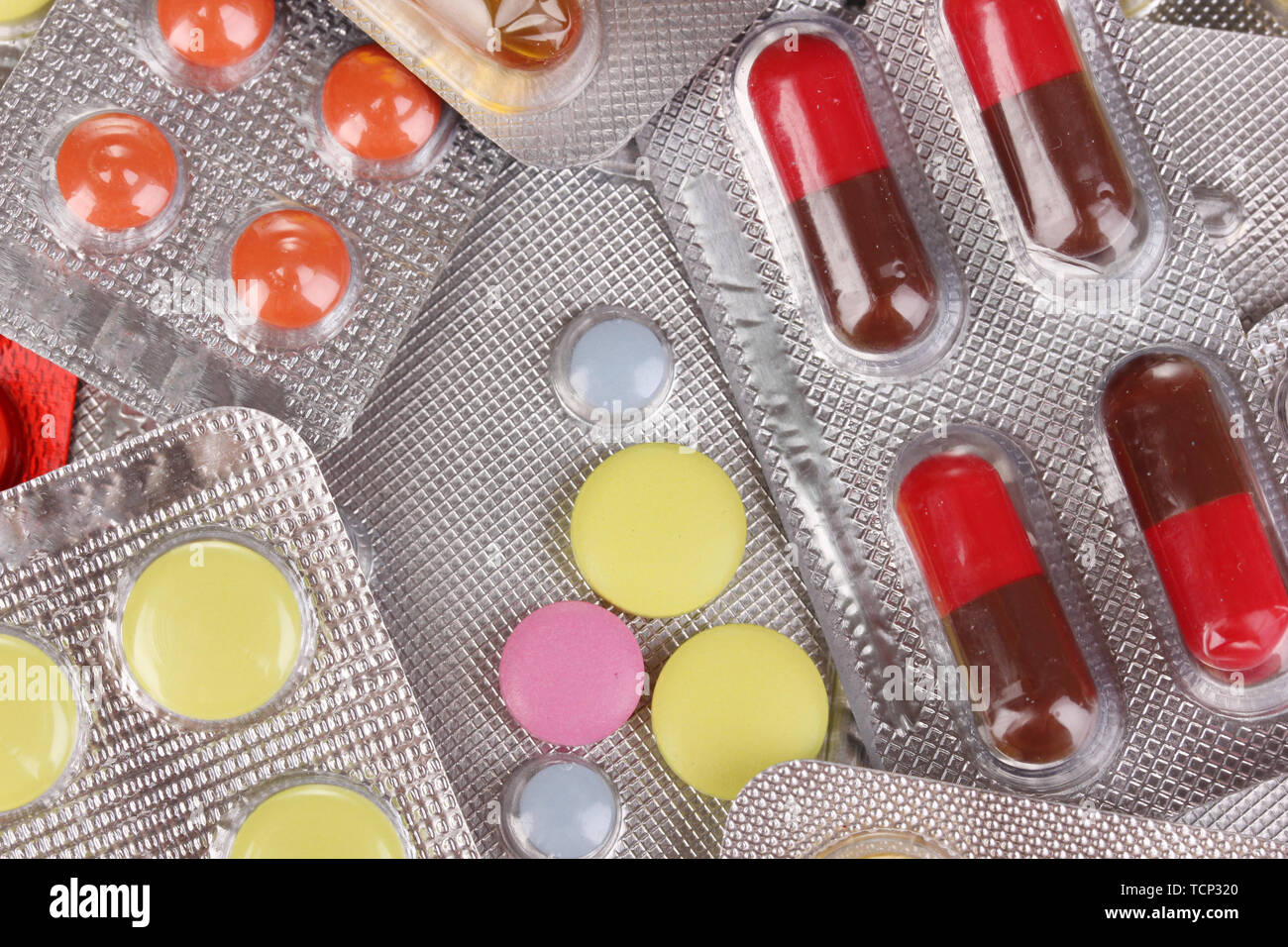 Capsules and pills packed in blisters close-up background Stock Photo ...