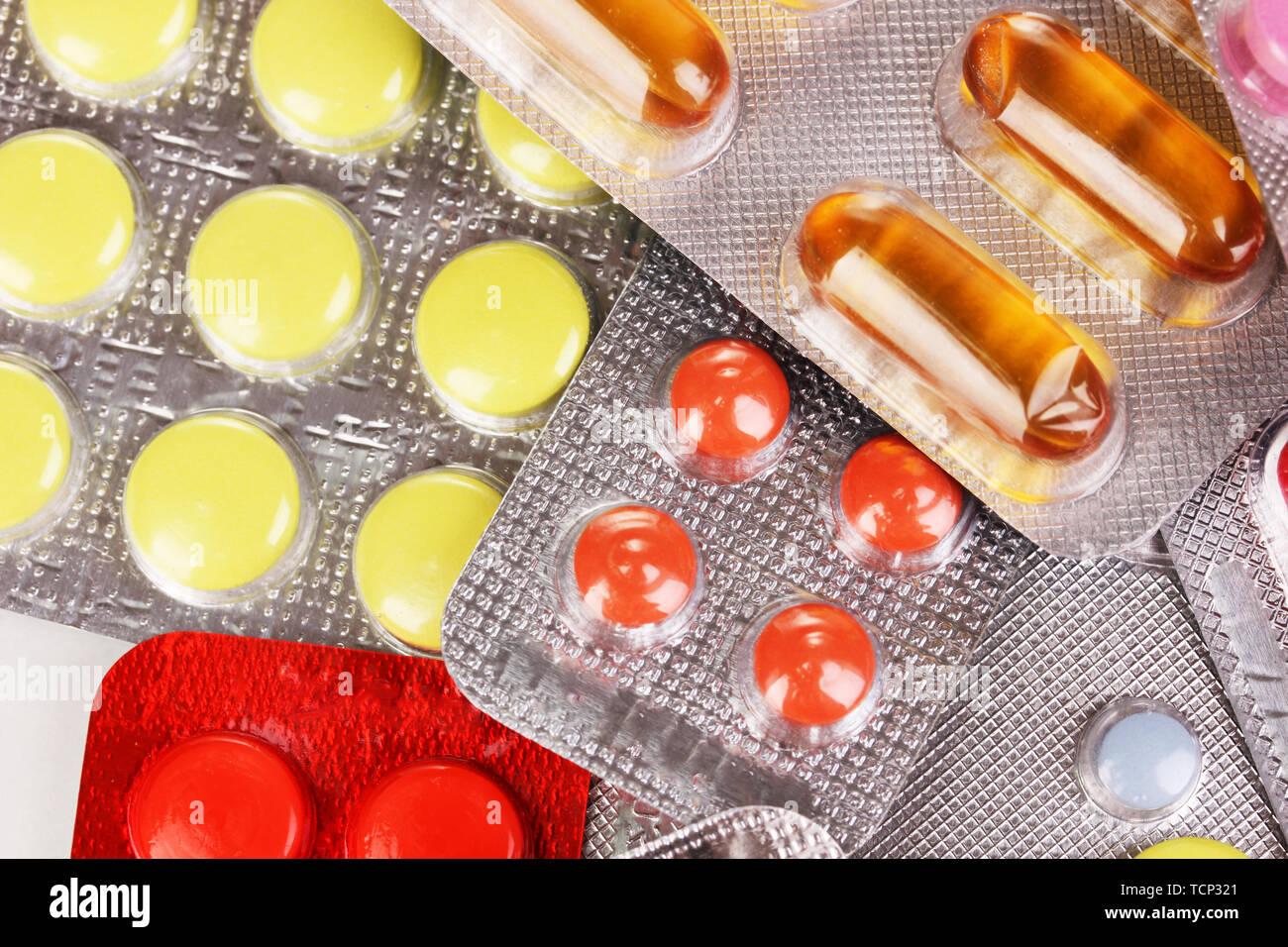 Capsules and pills packed in blisters close-up background Stock Photo ...