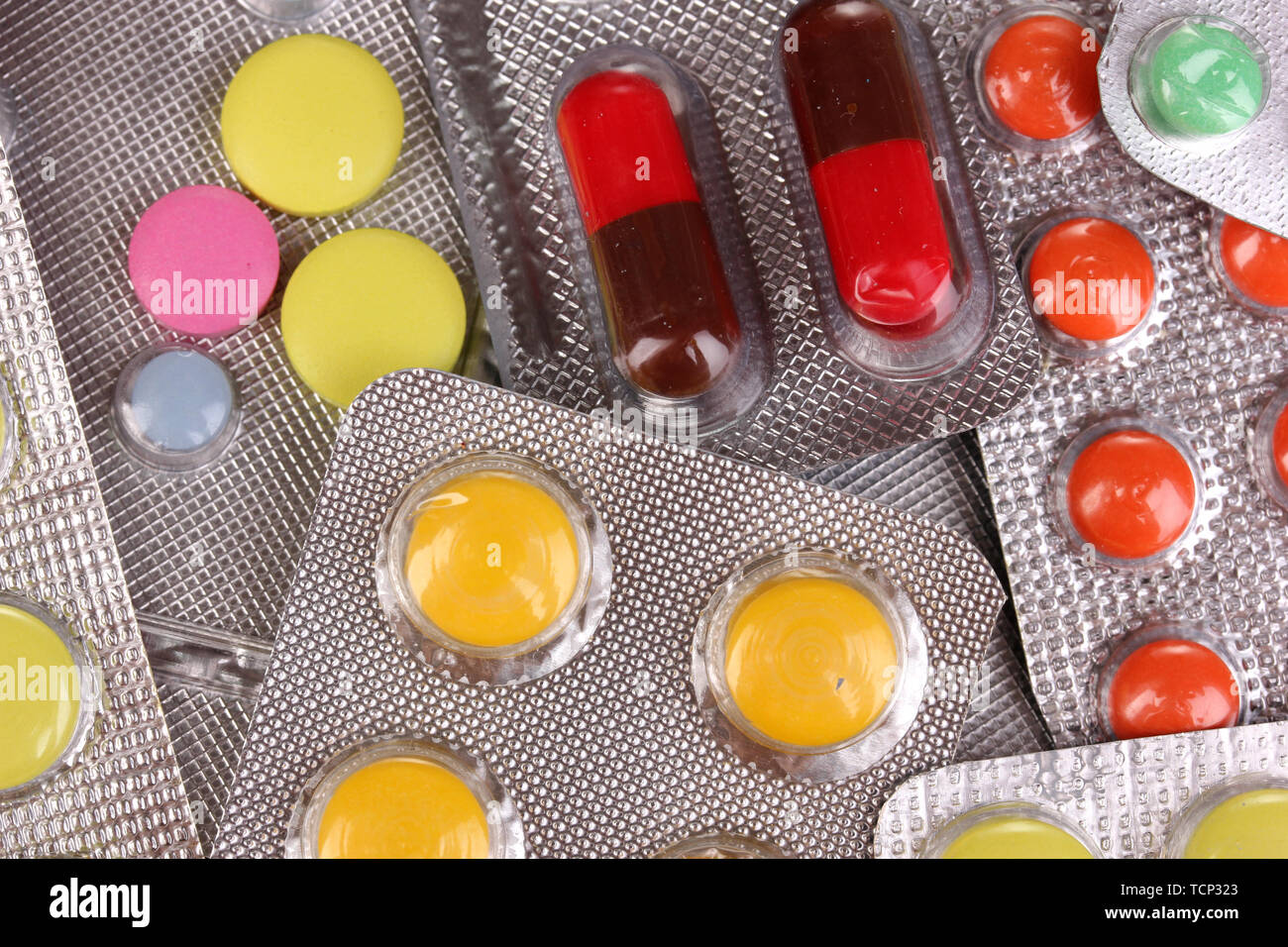 Capsules and pills packed in blisters close-up background Stock Photo ...
