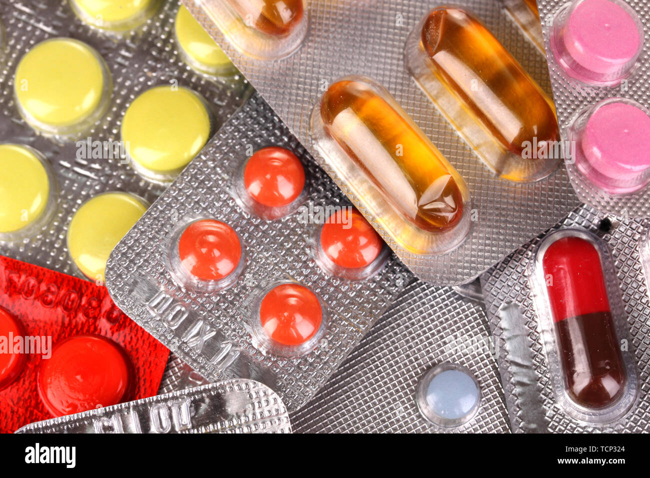 Capsules and pills packed in blisters close-up background Stock Photo ...