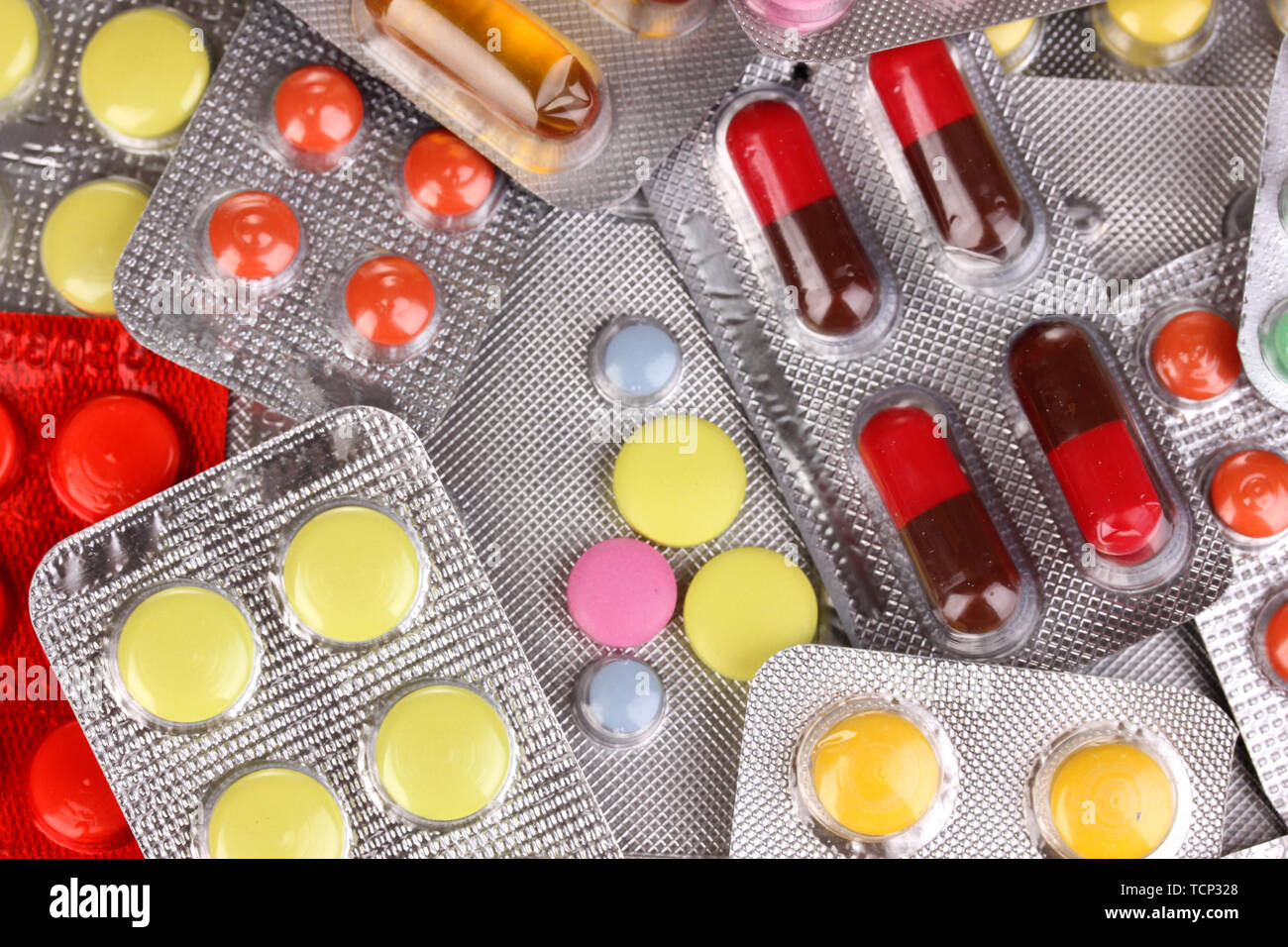 Capsules and pills packed in blisters close-up background Stock Photo ...