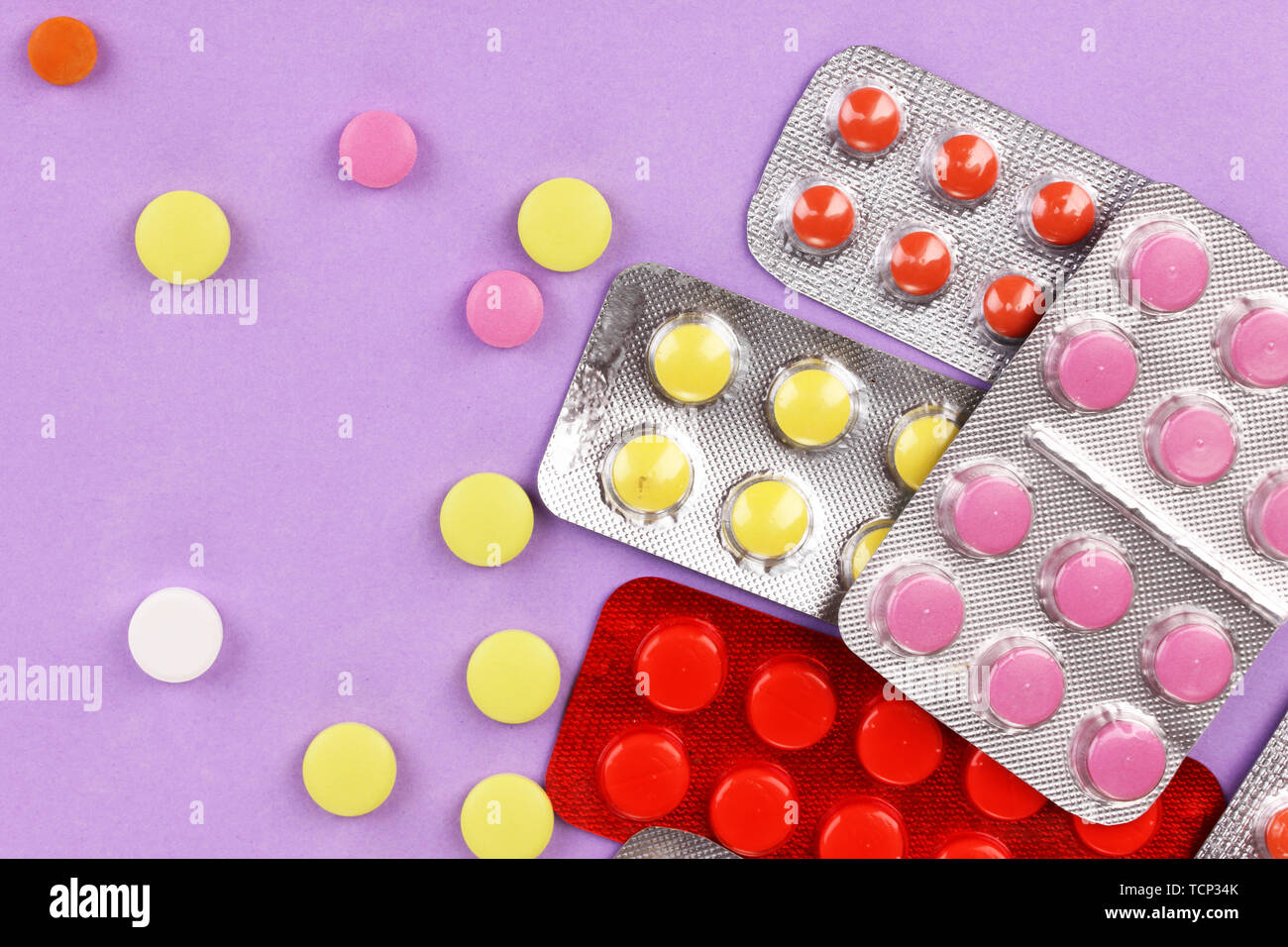 Capsules and pills packed in blisters on purple background Stock Photo ...