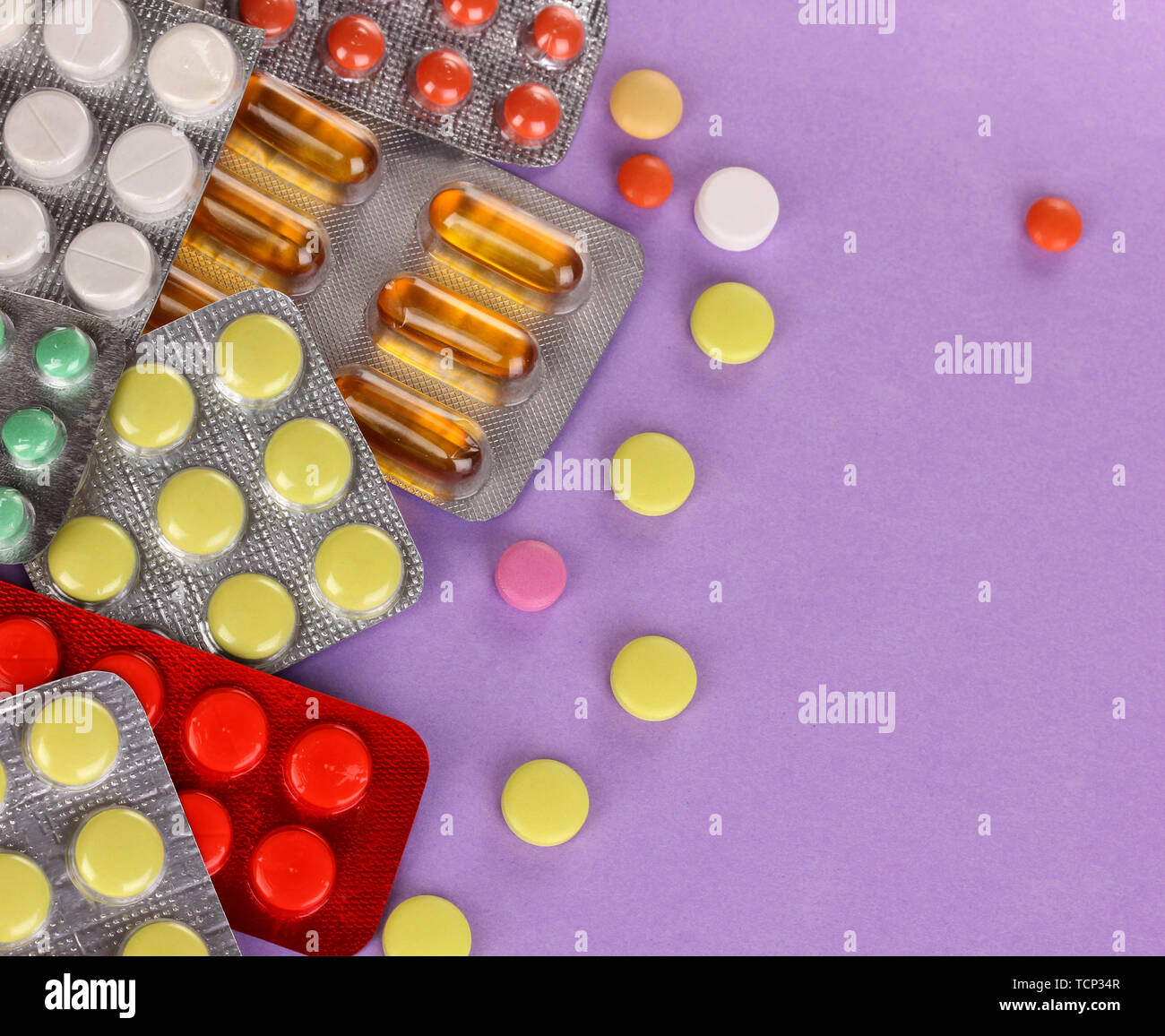Capsules and pills packed in blisters on purple background Stock Photo ...