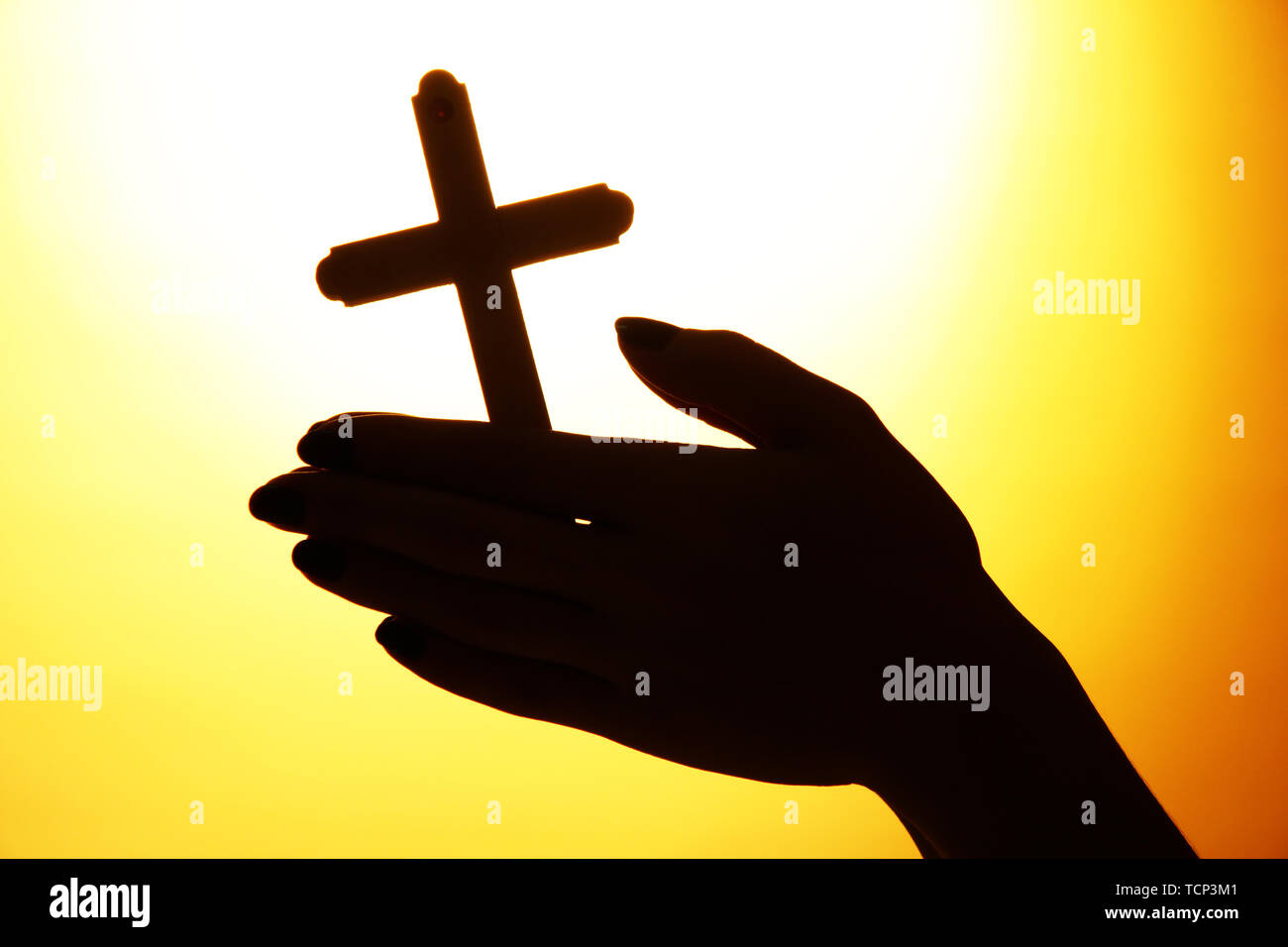 female hands with crucifix, on yellow background Stock Photo - Alamy