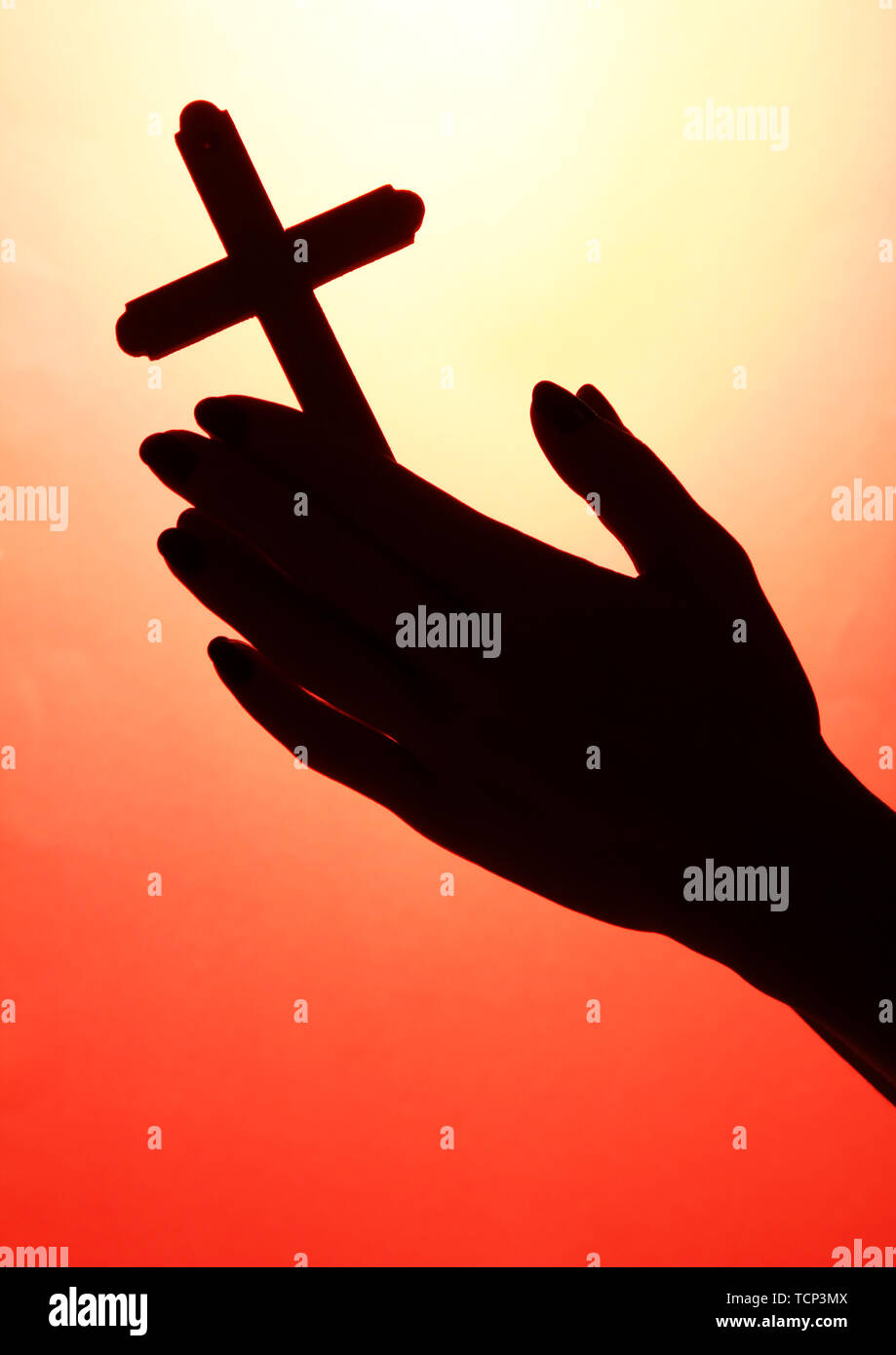 female hands with crucifix, on red background Stock Photo - Alamy