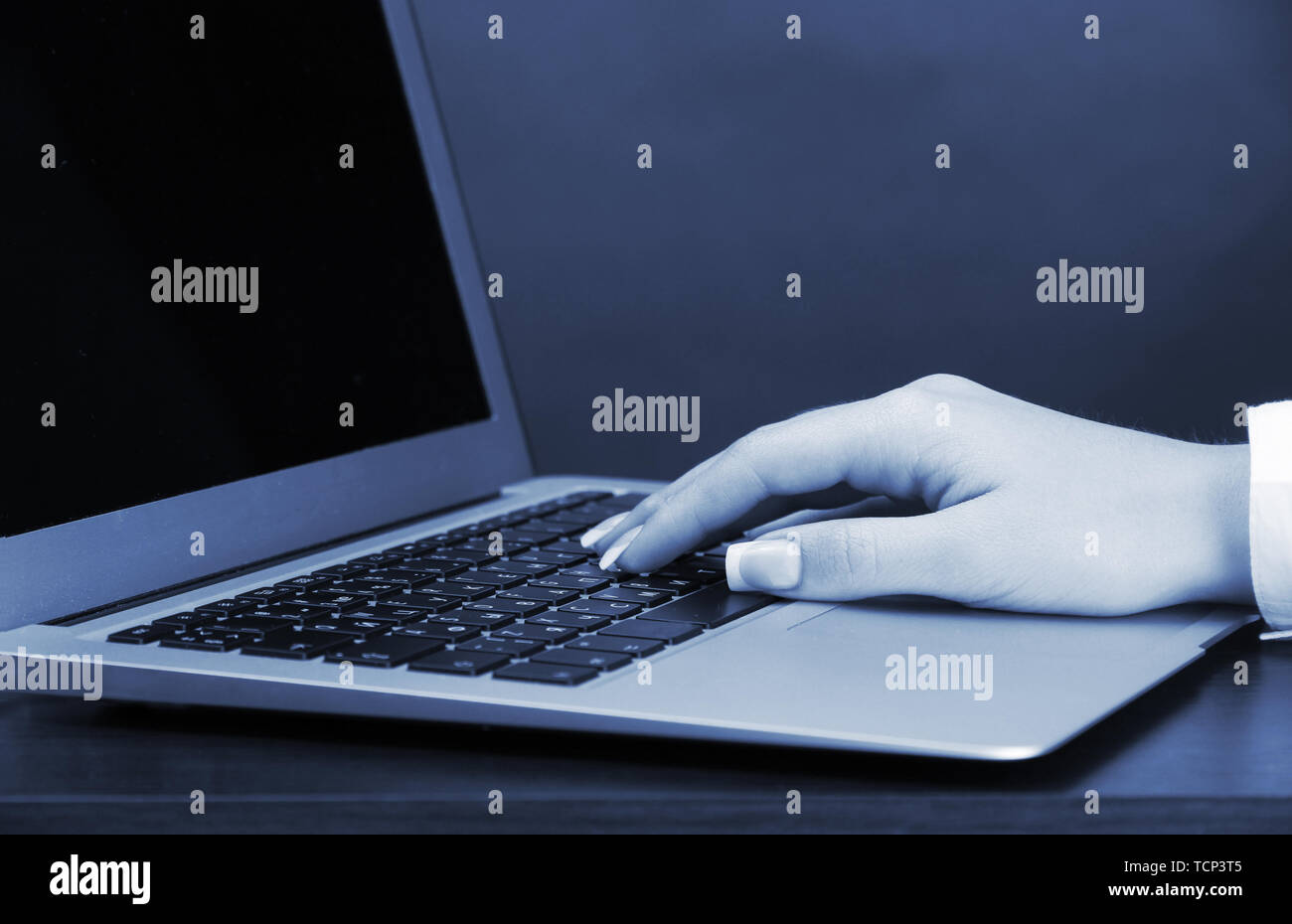 Female hands typing on laptot in blue light close-up Stock Photo - Alamy