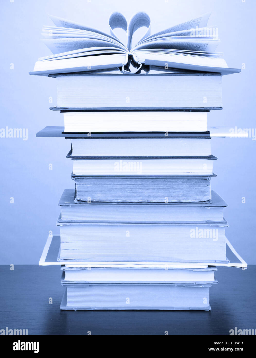 Stack of books in dark blue light Stock Photo - Alamy