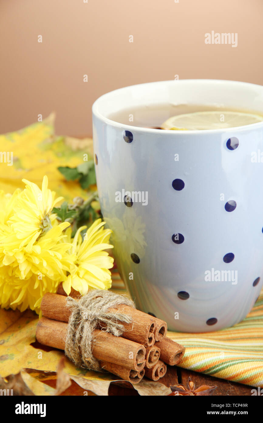 cup of hot tea and autumn leaves, on brown background Stock Photo - Alamy