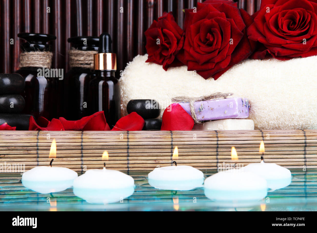 Beautiful spa setting near pool on bamboo background Stock Photo - Alamy