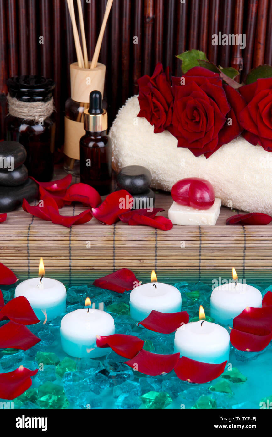 Beautiful spa setting near pool on bamboo background Stock Photo - Alamy