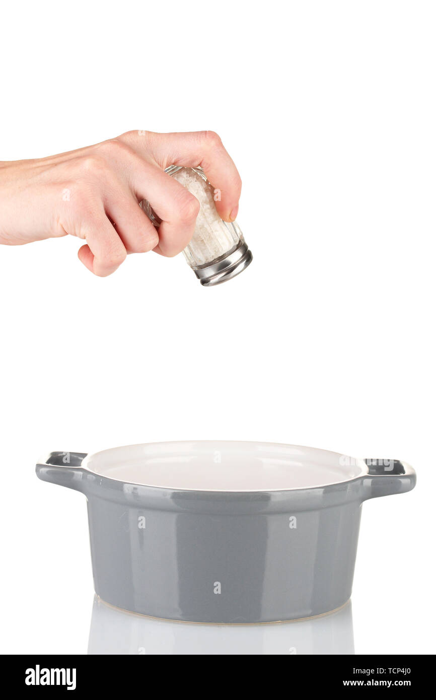 Hand adding salt using salt shaker isolated on white Stock Photo - Alamy