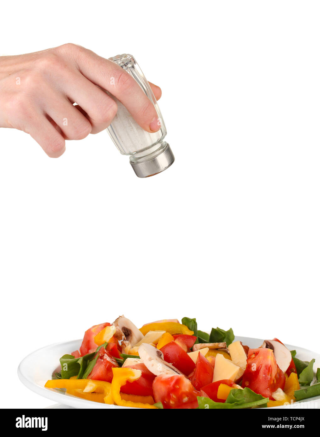 Hand adding salt using salt shaker isolated on white Stock Photo - Alamy
