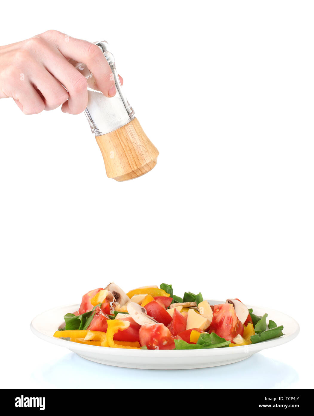 Hand adding salt using salt shaker isolated on white Stock Photo - Alamy