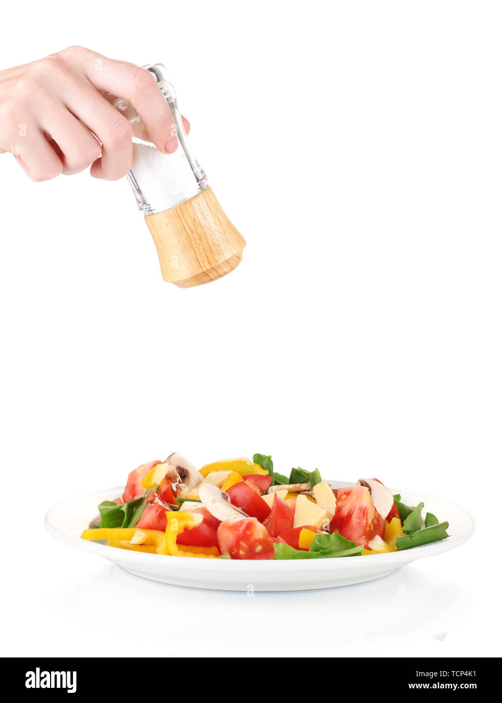Hand adding salt using salt shaker isolated on white Stock Photo - Alamy