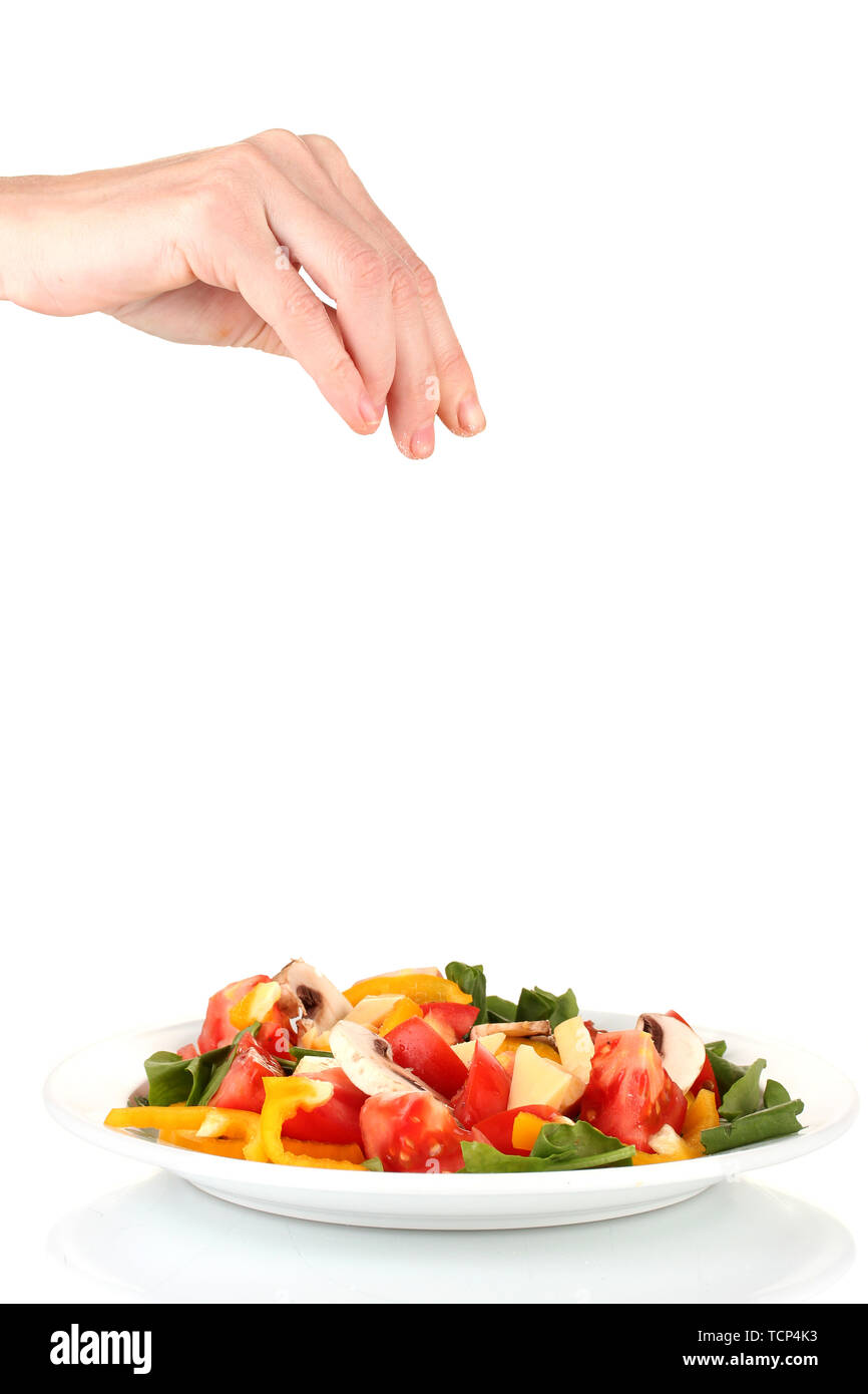 Hand adding salt isolated on white Stock Photo - Alamy