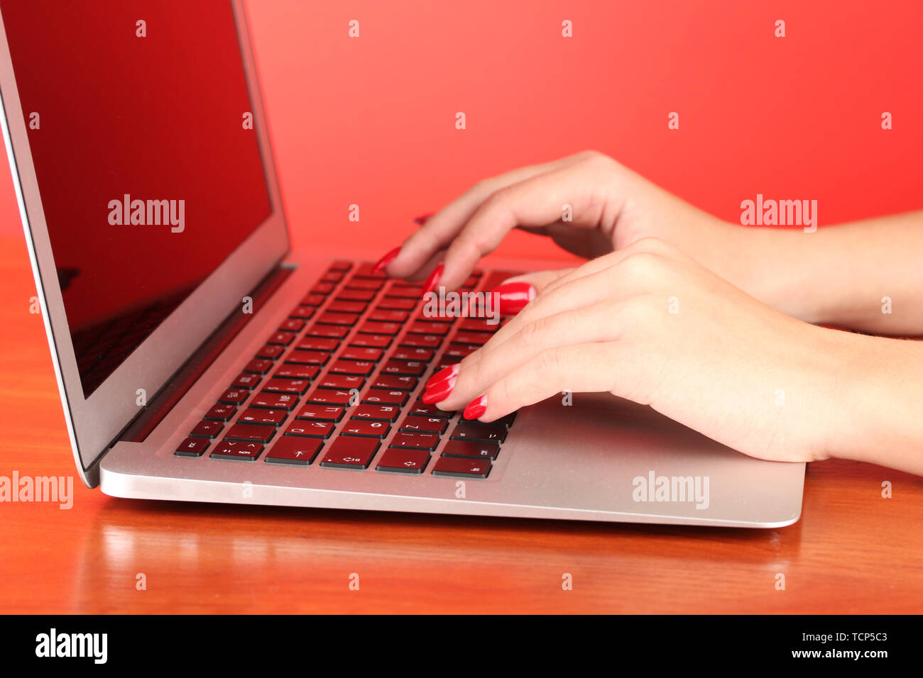 Detail of female hands using computer on color background Stock Photo ...